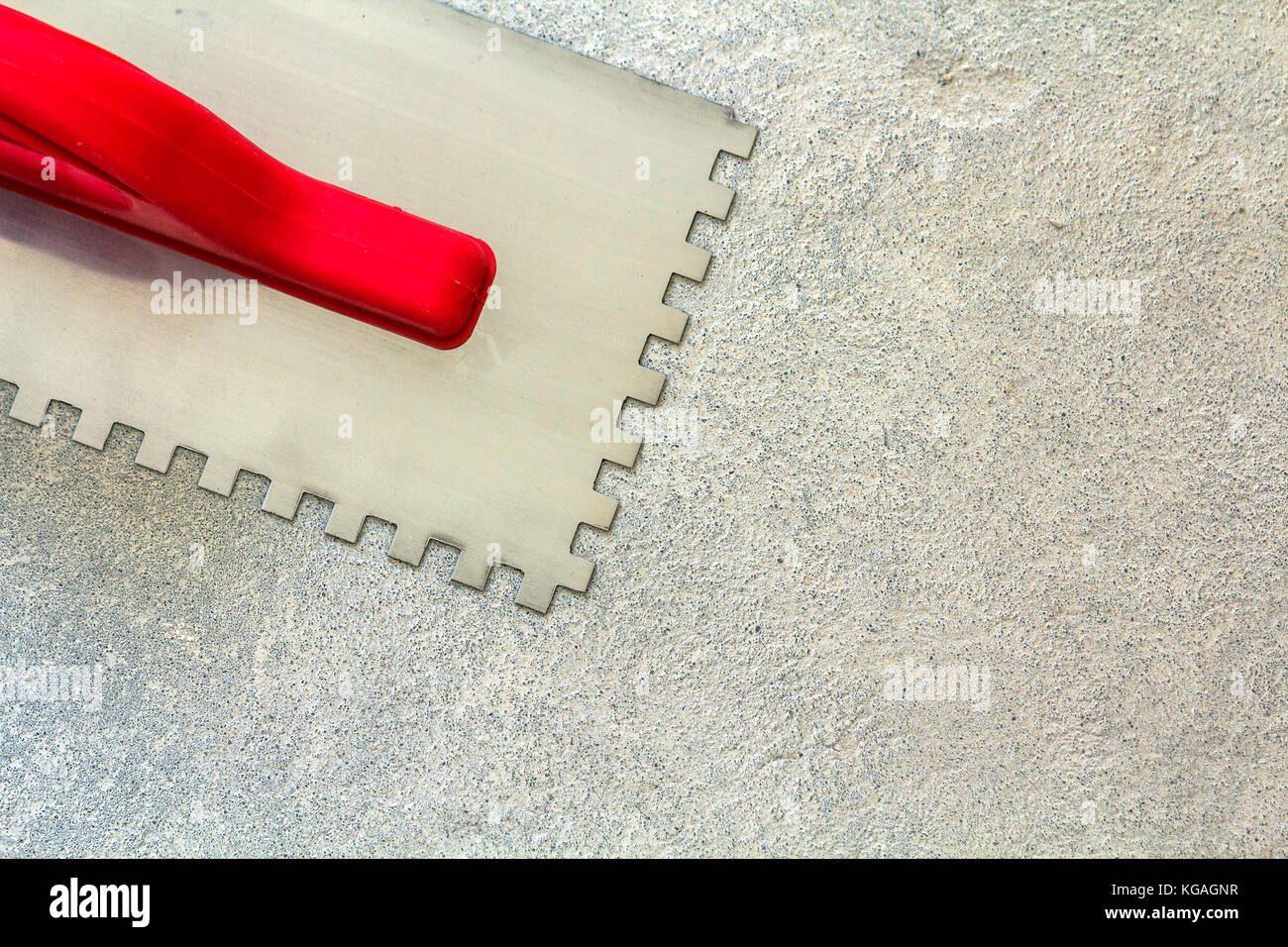 Construction notched trowel is a tool for tiles installation work Stock ...
