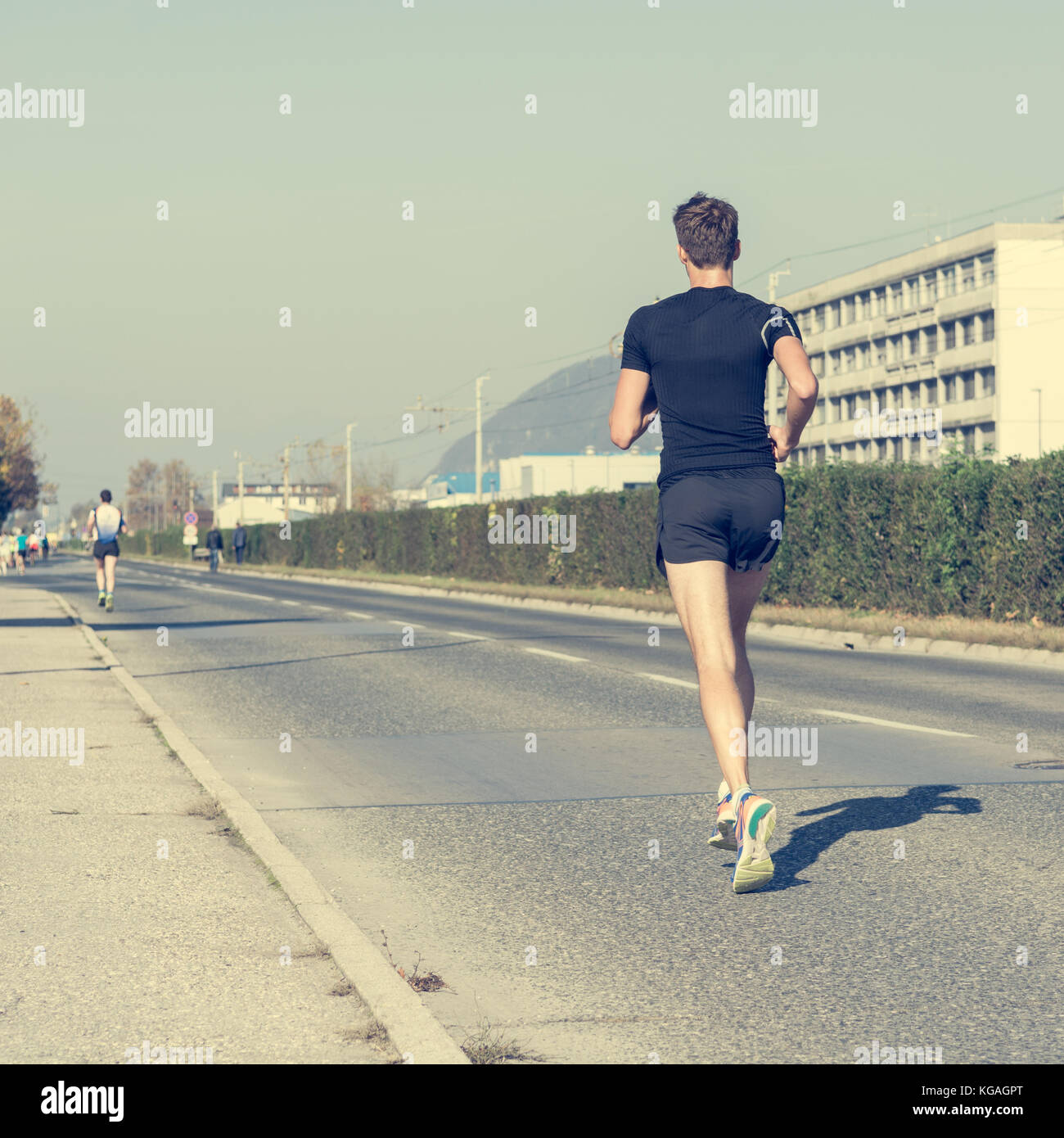 Lonely marahon runner catching up Stock Photo - Alamy