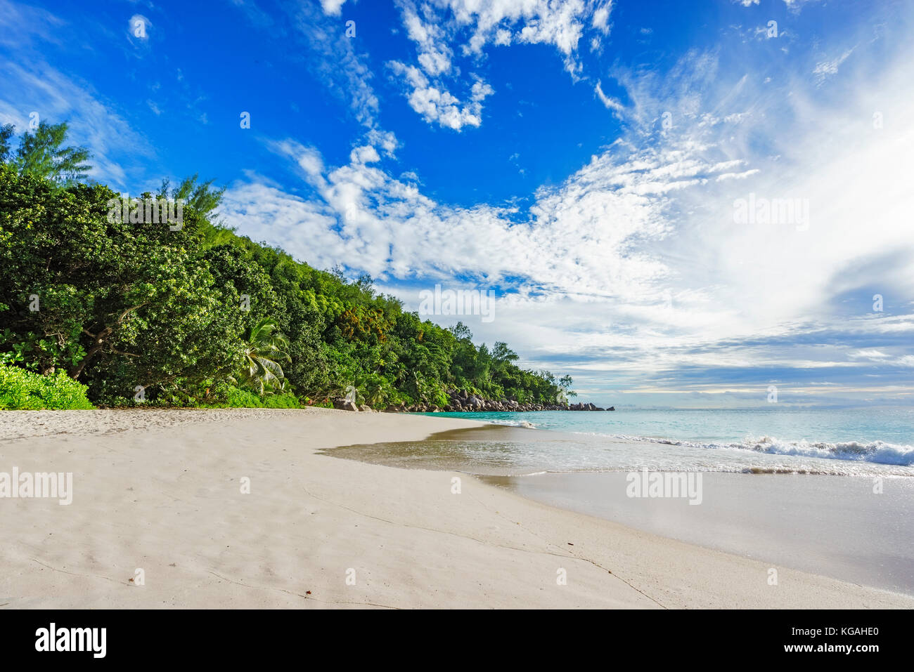 sunny day on paradise beach with big granite rocks, turquoise water ...