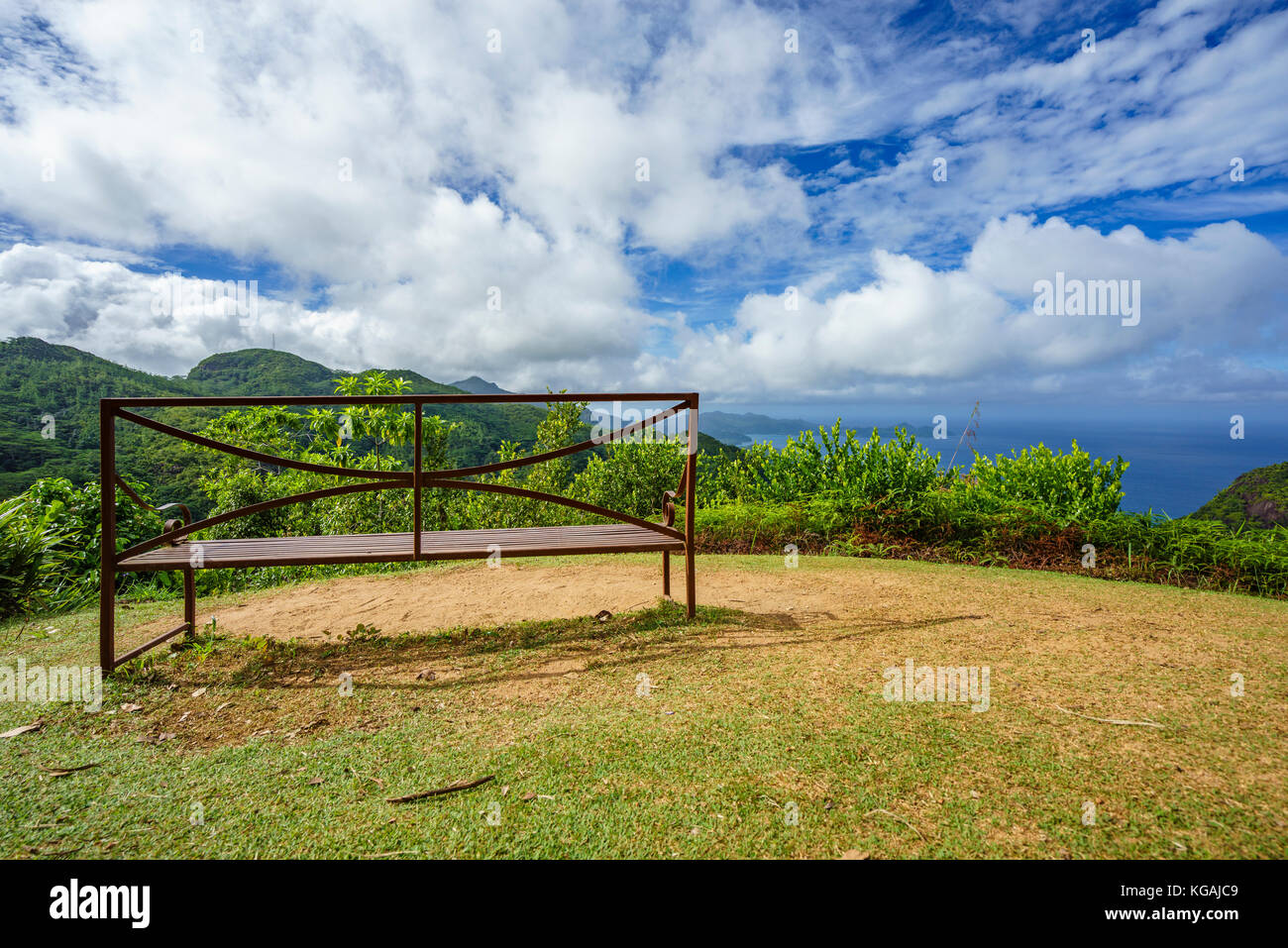 Beautiful bench in front with a panoramic overview over the mountains ...