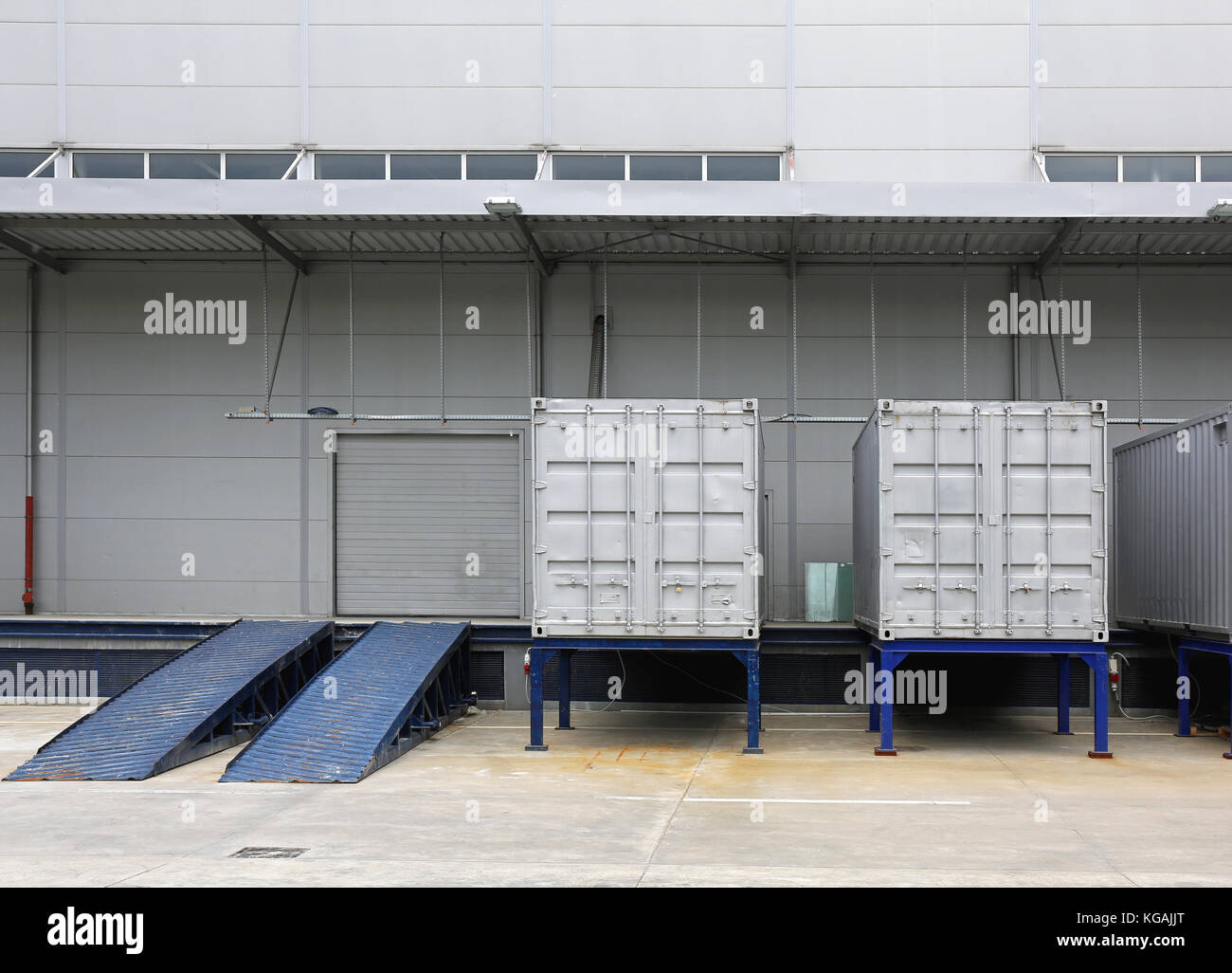 Silver Shipping Containers and Ramp in Front of Warehouse Stock Photo ...