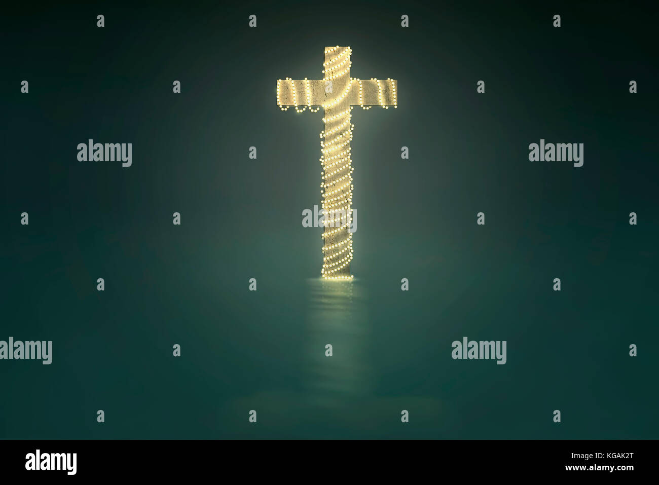 Cross with christmas lights decoration on green background Stock Photo ...