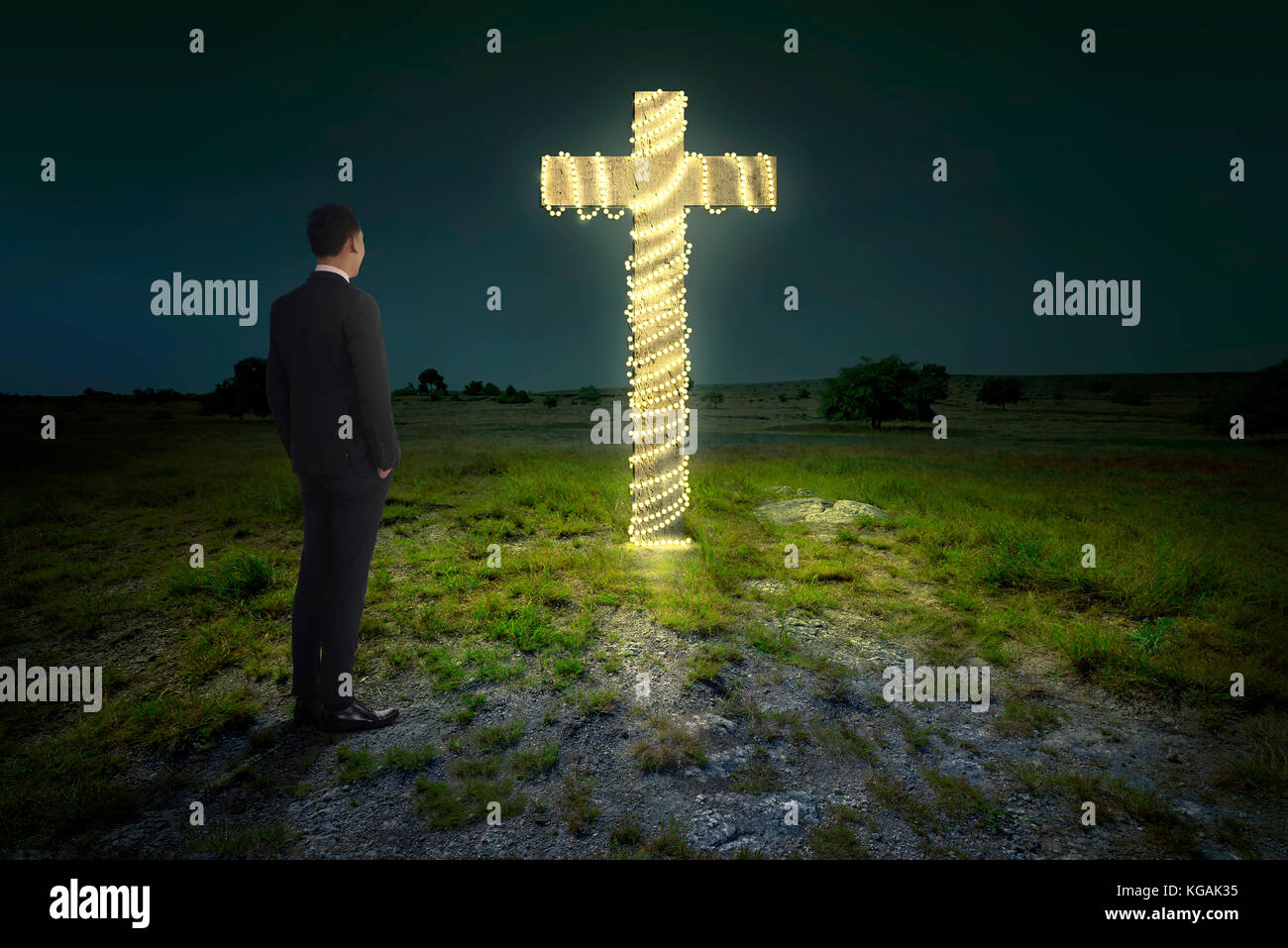 Business man looking cross shape with christmas lights decoration on ...