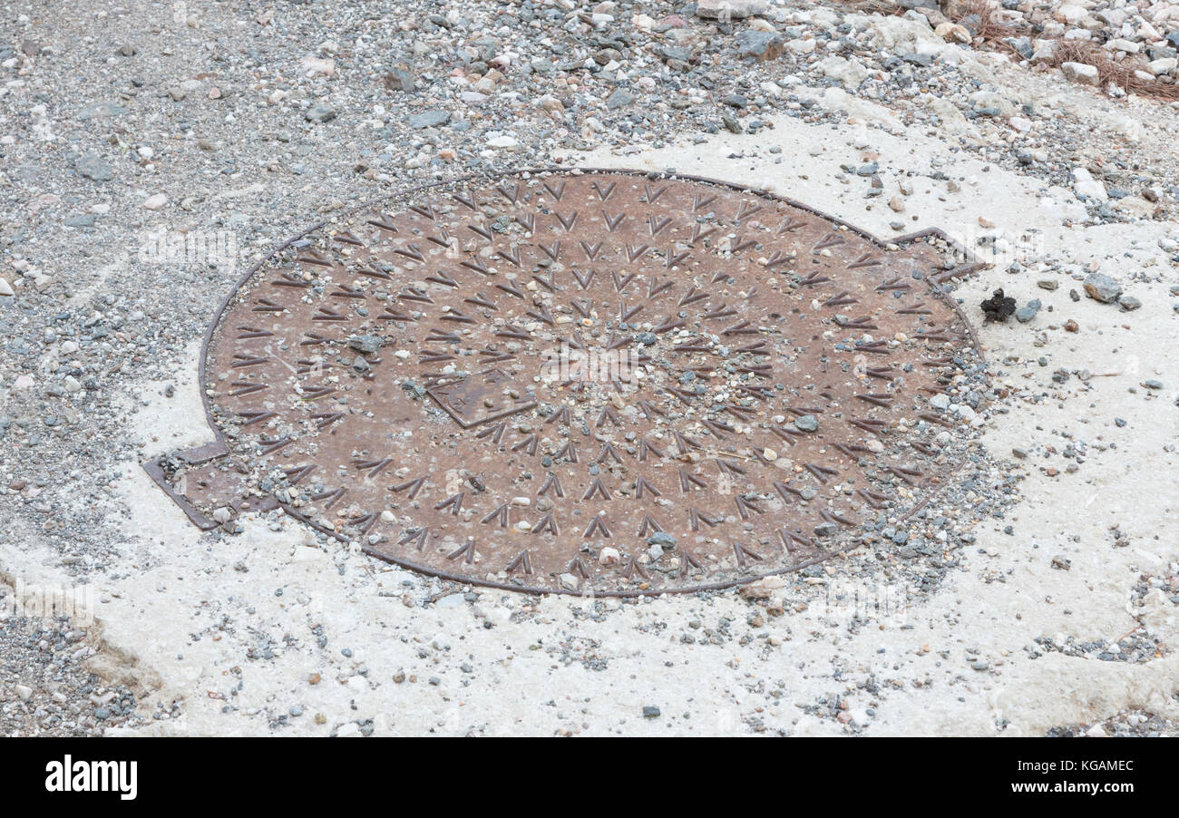 Circle steel manhole cover or metal sewer on a street in Greece Stock ...