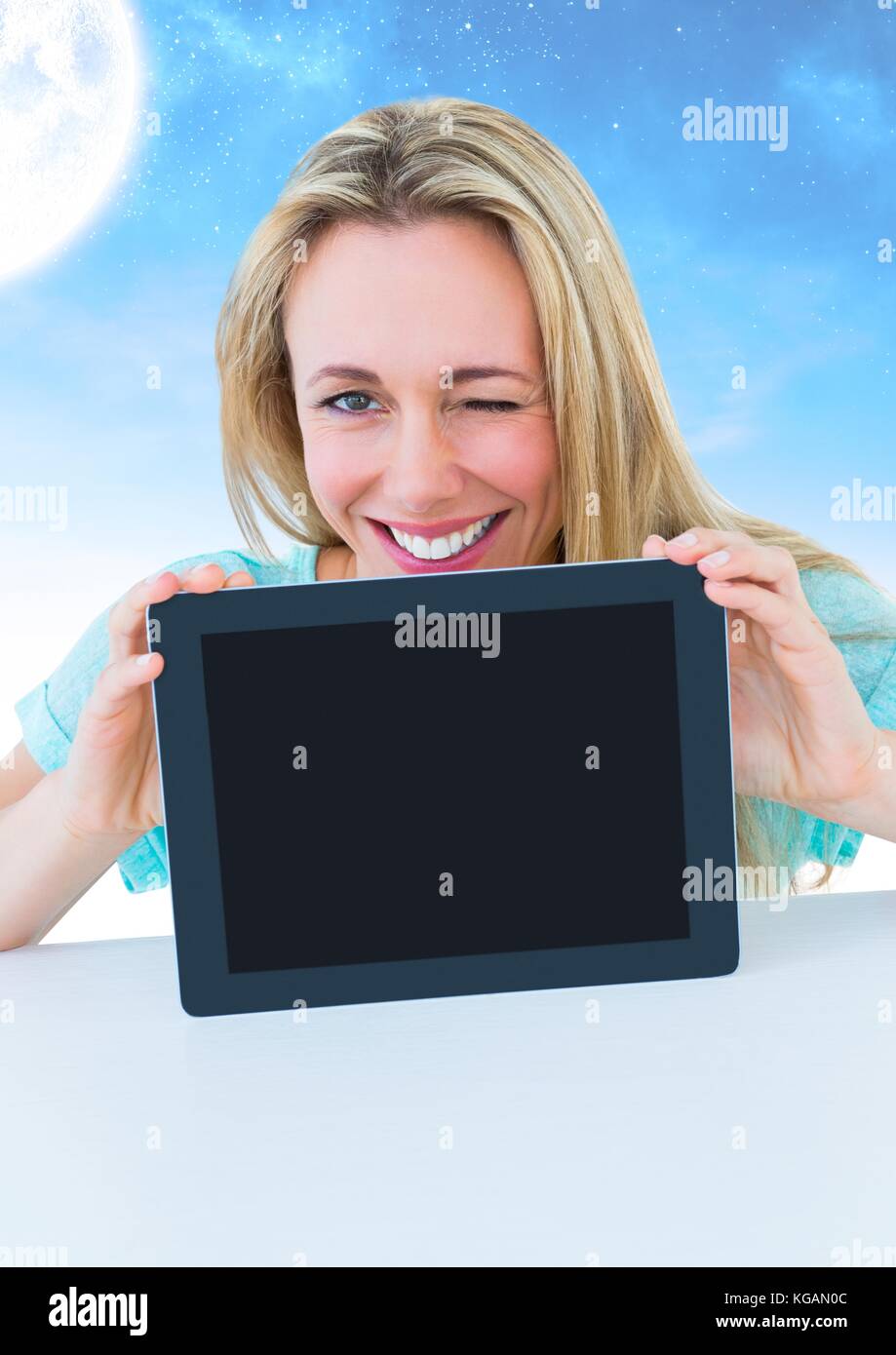 Digital composite of Woman holding tablet with moon background Stock ...