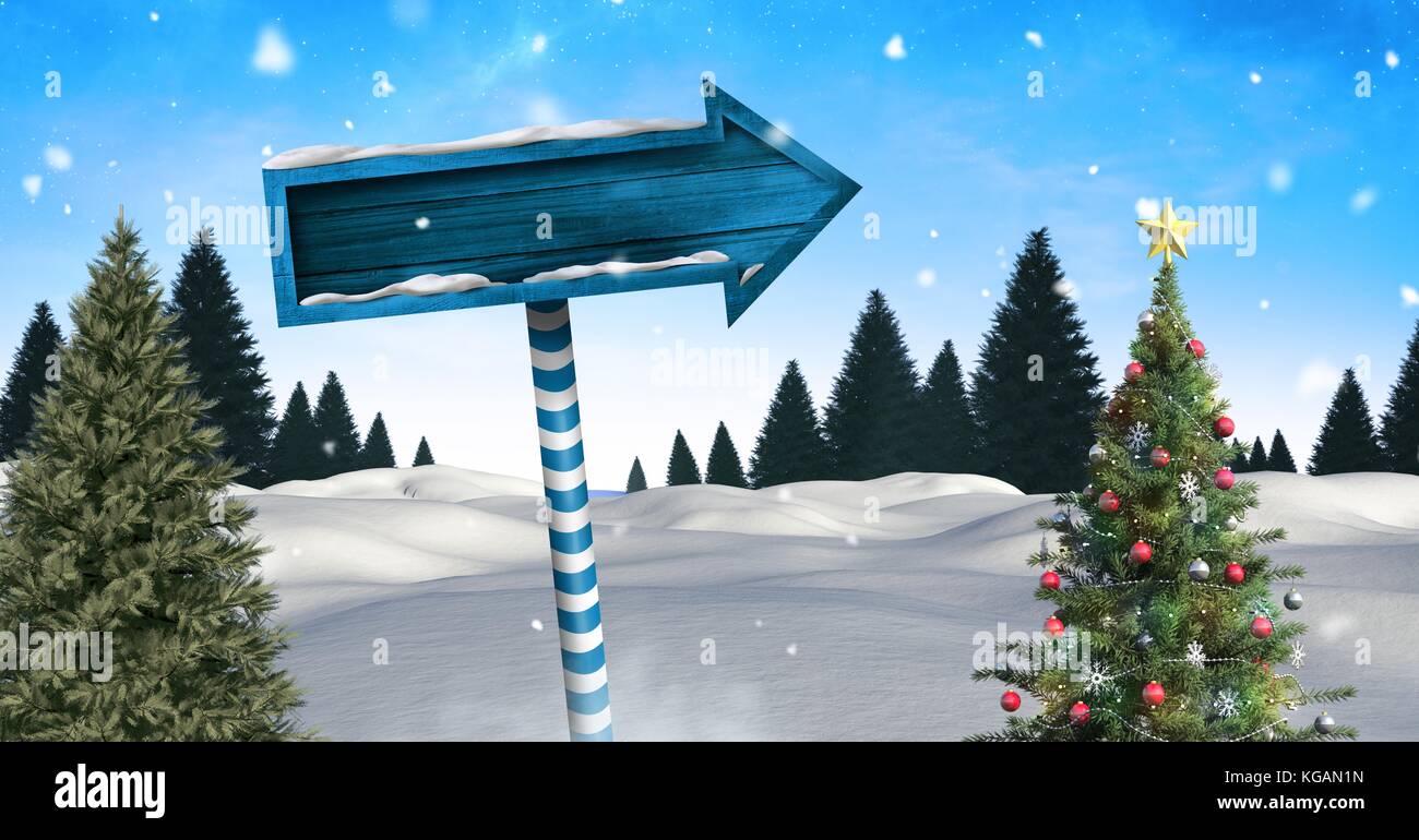 Digital composite of Wooden signpost in Christmas Winter landscape with ...