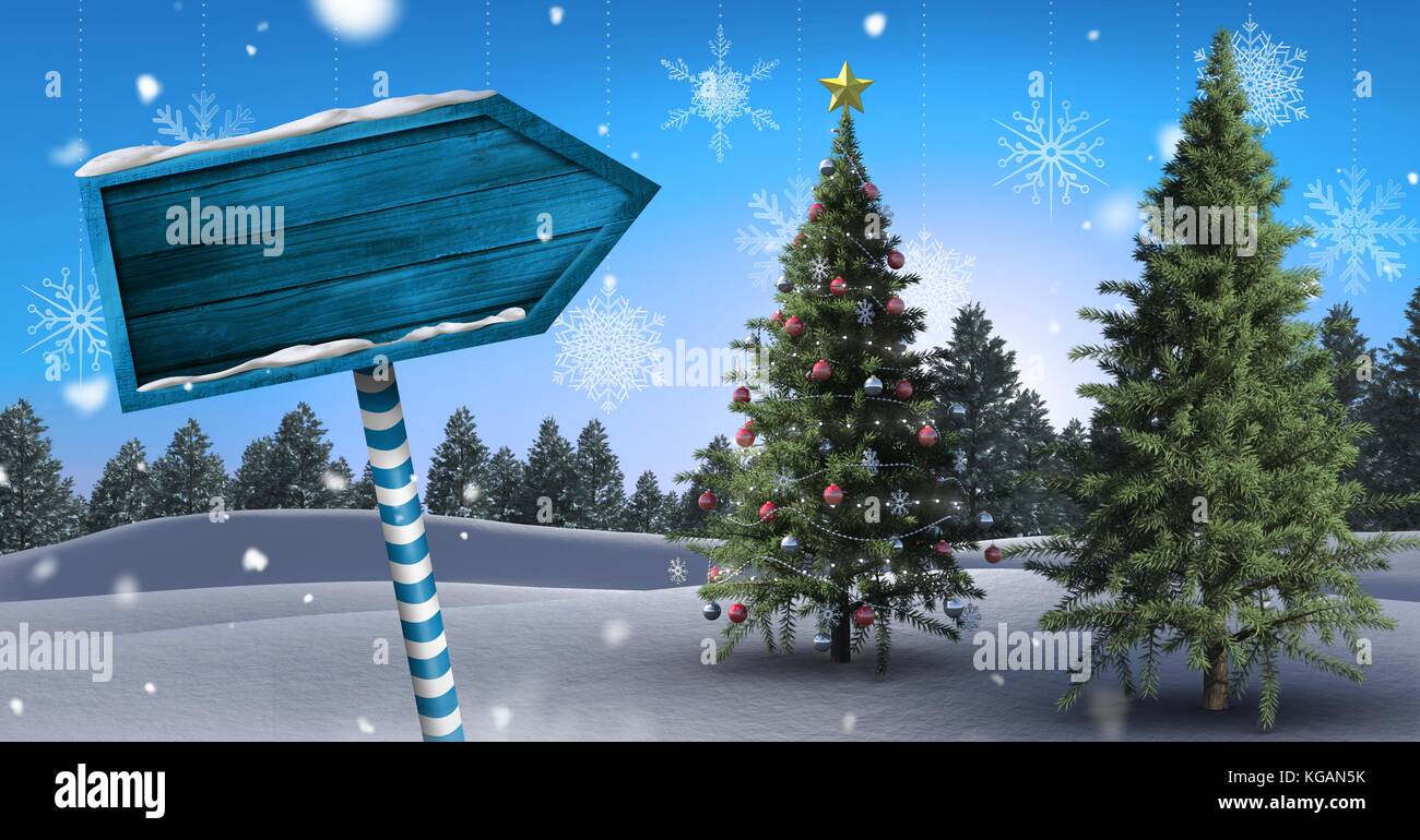 Digital composite of Wooden signpost in Christmas Winter landscape with ...