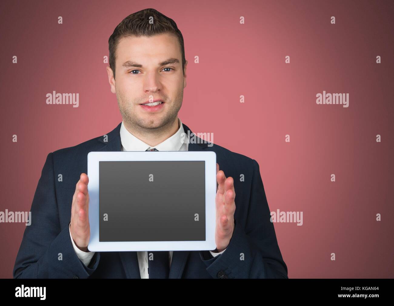 Digital composite of Man holding tablet with red background Stock Photo ...
