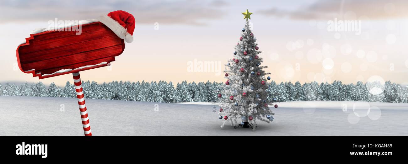 Digital composite of Wooden signpost in Christmas Winter landscape and ...