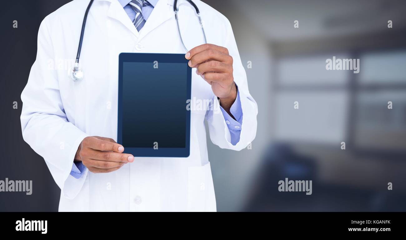 Digital composite of Doctor holding tablet with office background Stock ...