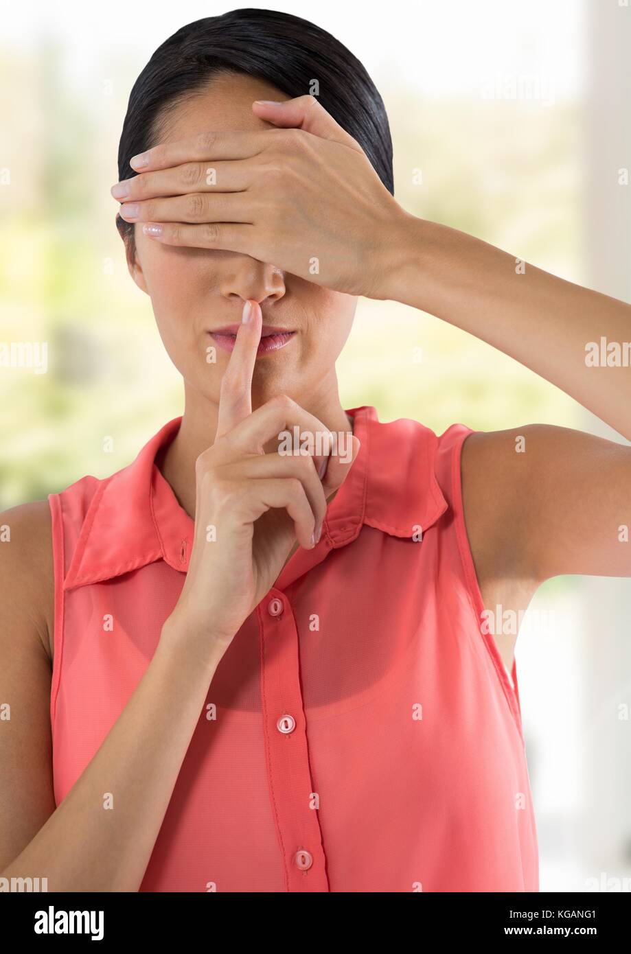 Digital composite of Woman hushing quiet with finger and hand over eyes ...