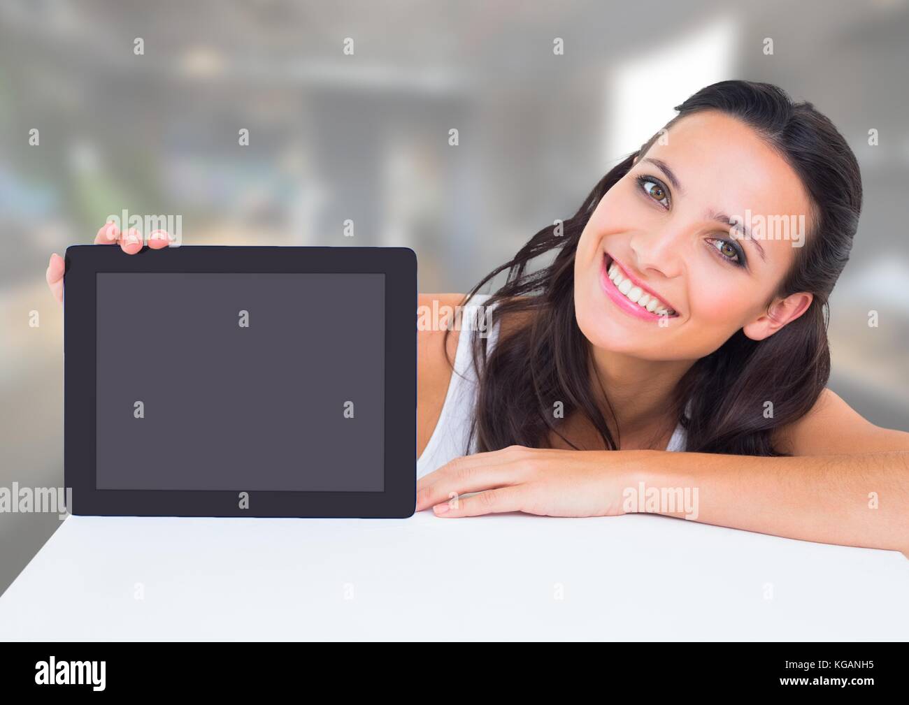 Digital composite of Woman holding tablet with office background Stock ...