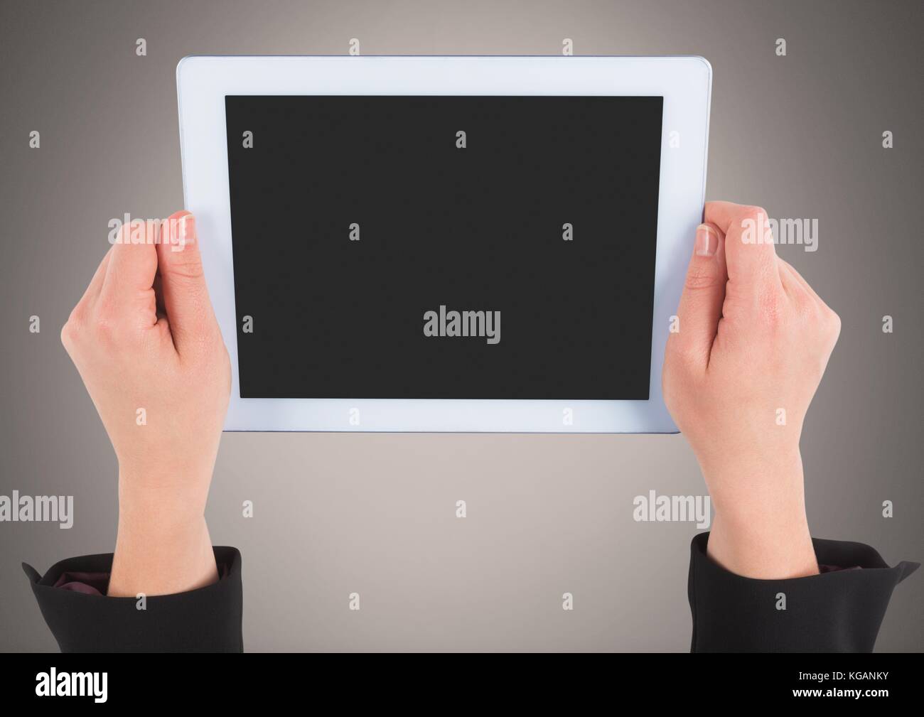 Digital composite of Hand holding tablet with grey background Stock ...