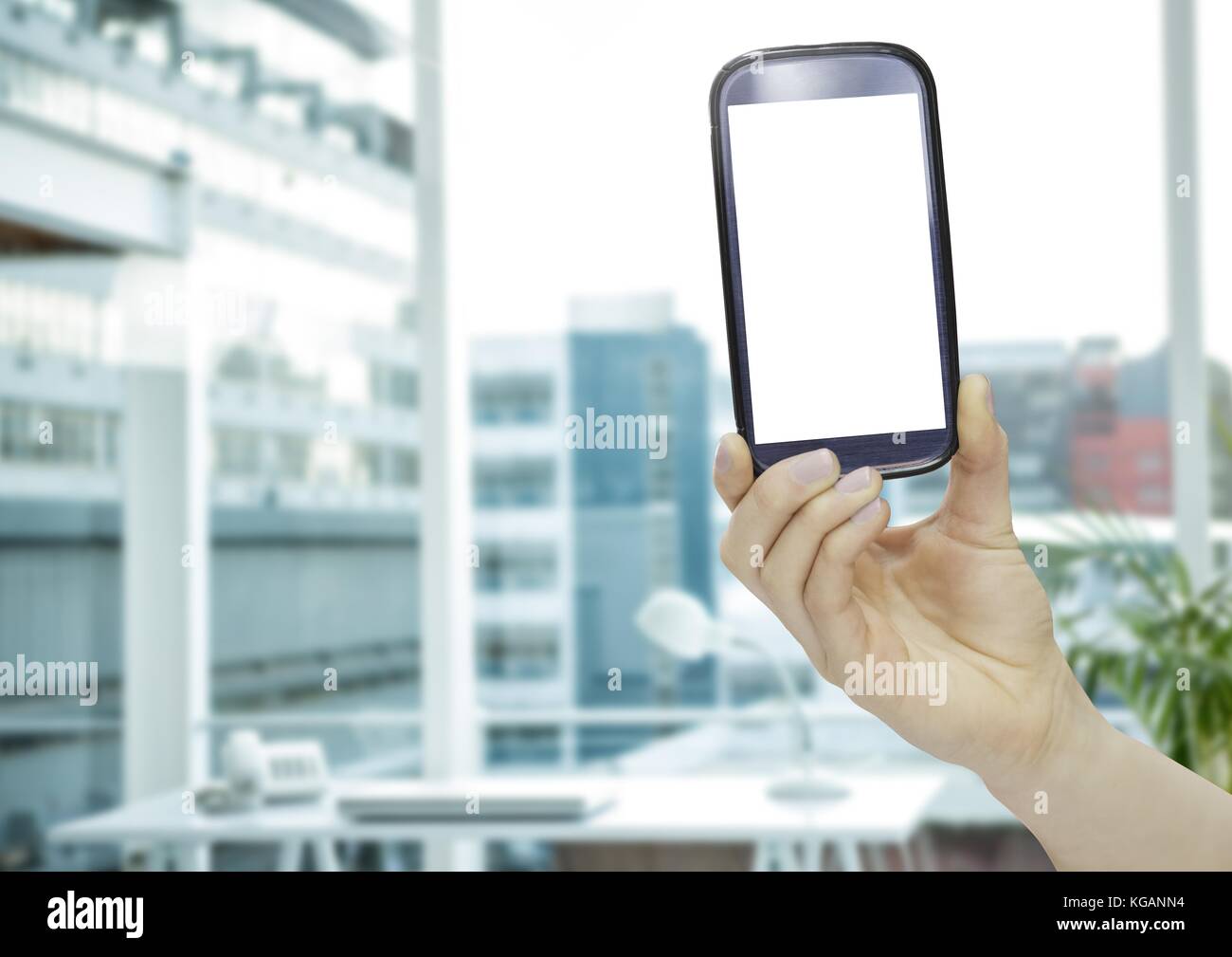 Digital composite of Hand using phone with office background Stock ...