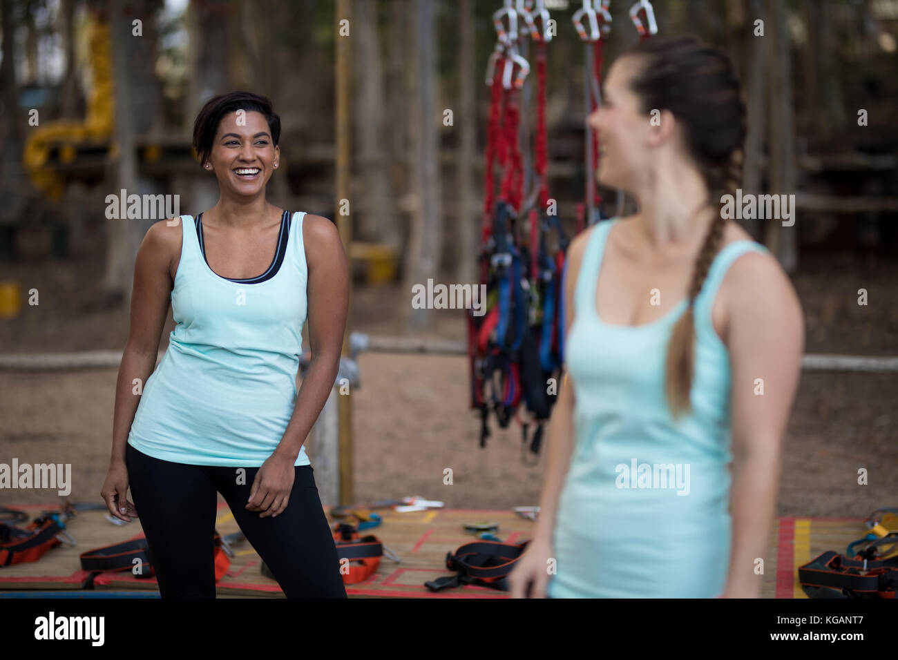 Happy friends interacting with each other in forest Stock Photo - Alamy