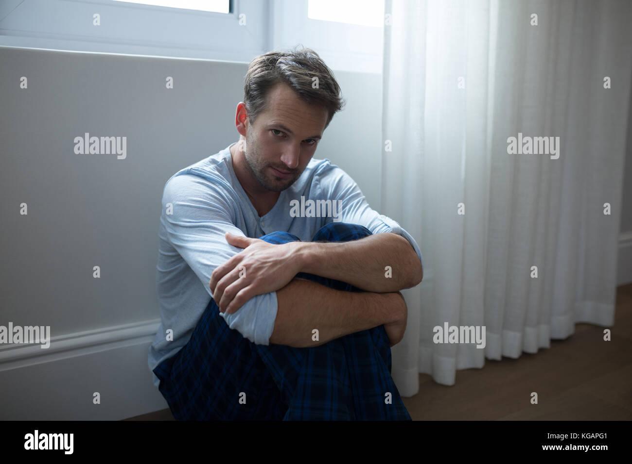 Sad man sitting at home hi-res stock photography and images - Alamy