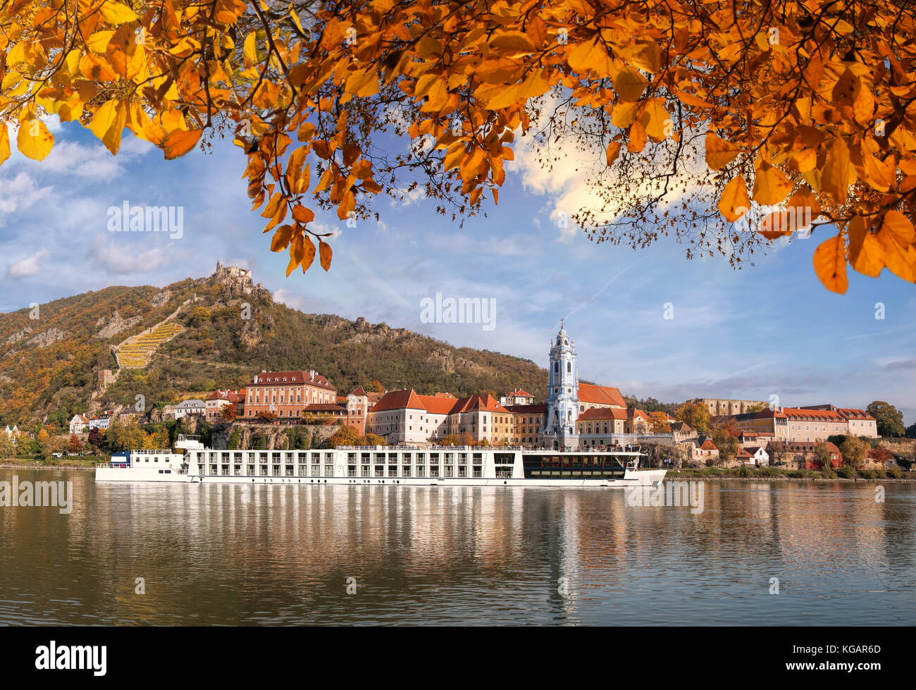 DUERNSTEIN CASTLE AND VILLAGE WITH BOAT ON DANUBE RIVER DURING AUTUMN ...