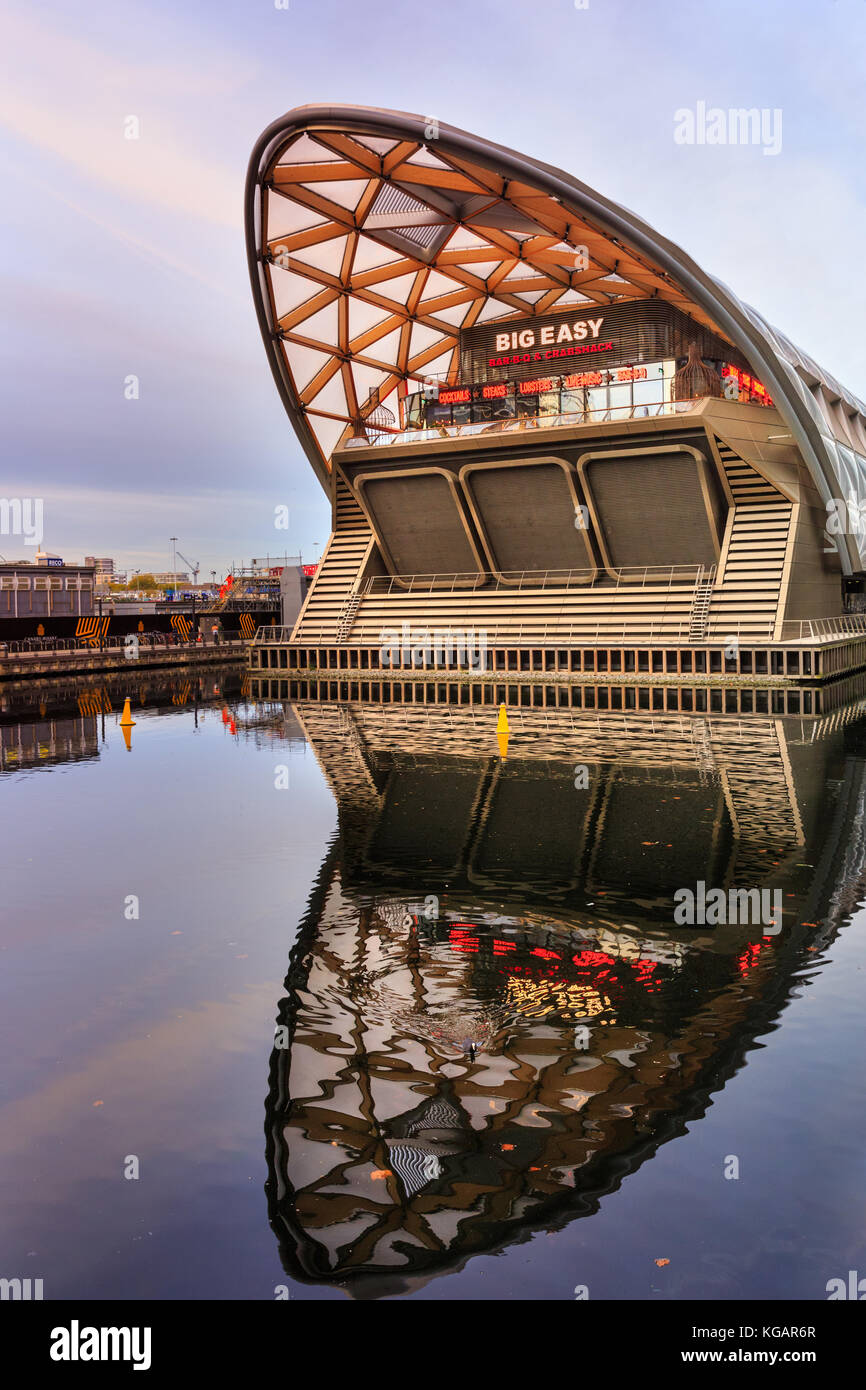 Crossrail Place architecture and rail station exterior at sunset ...