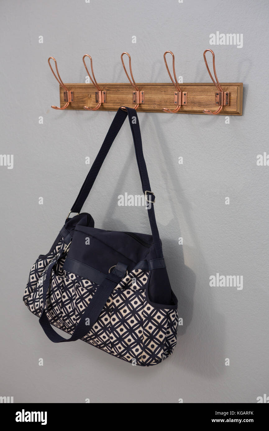 Bag hanging on hook against wall Stock Photo - Alamy