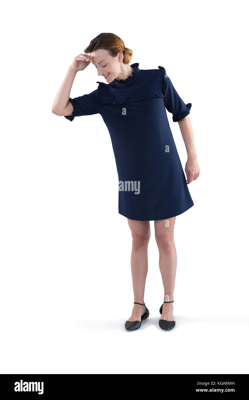 Female executive looking down against white background Stock Photo - Alamy