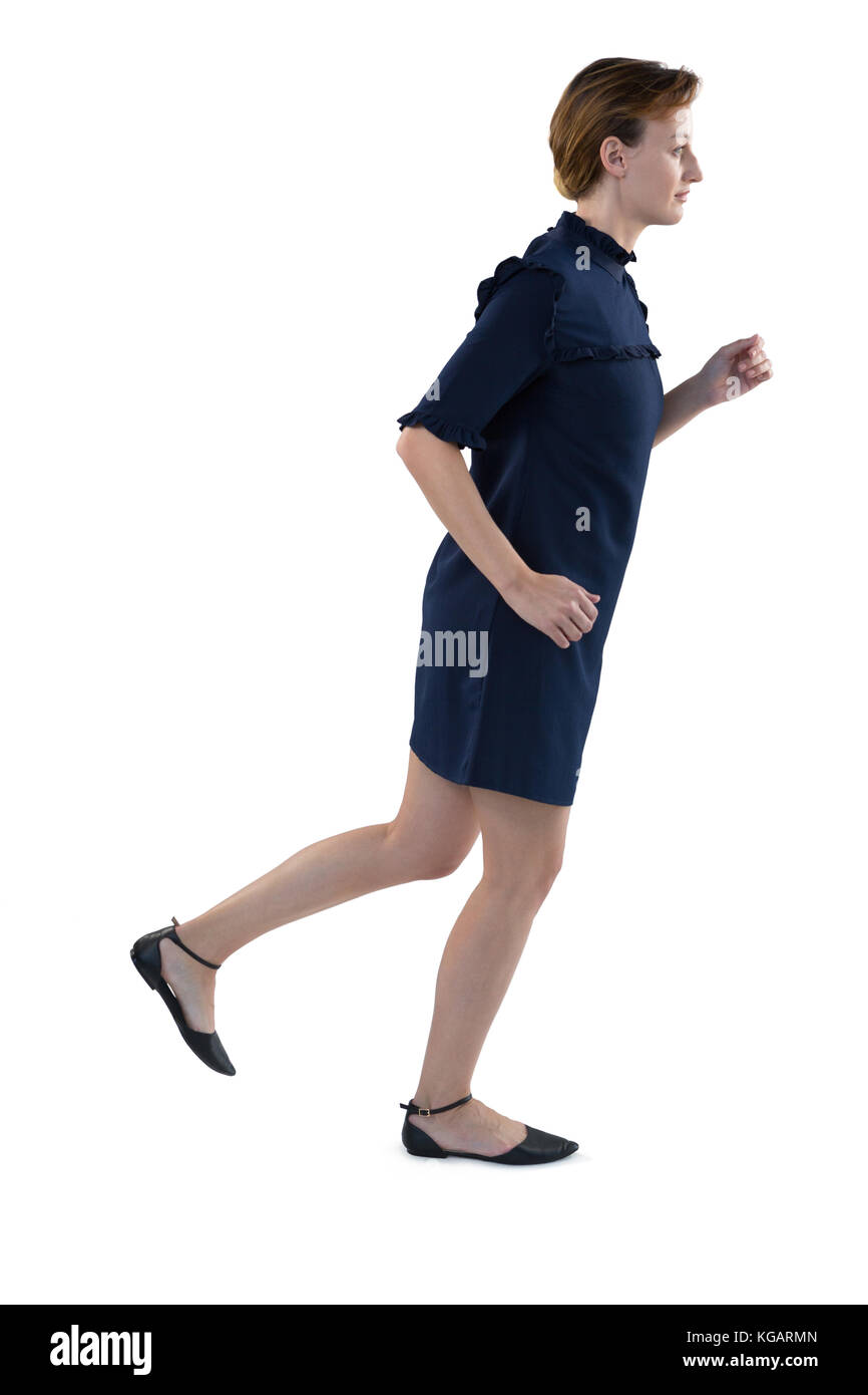 Side view of female executive running against white background Stock ...