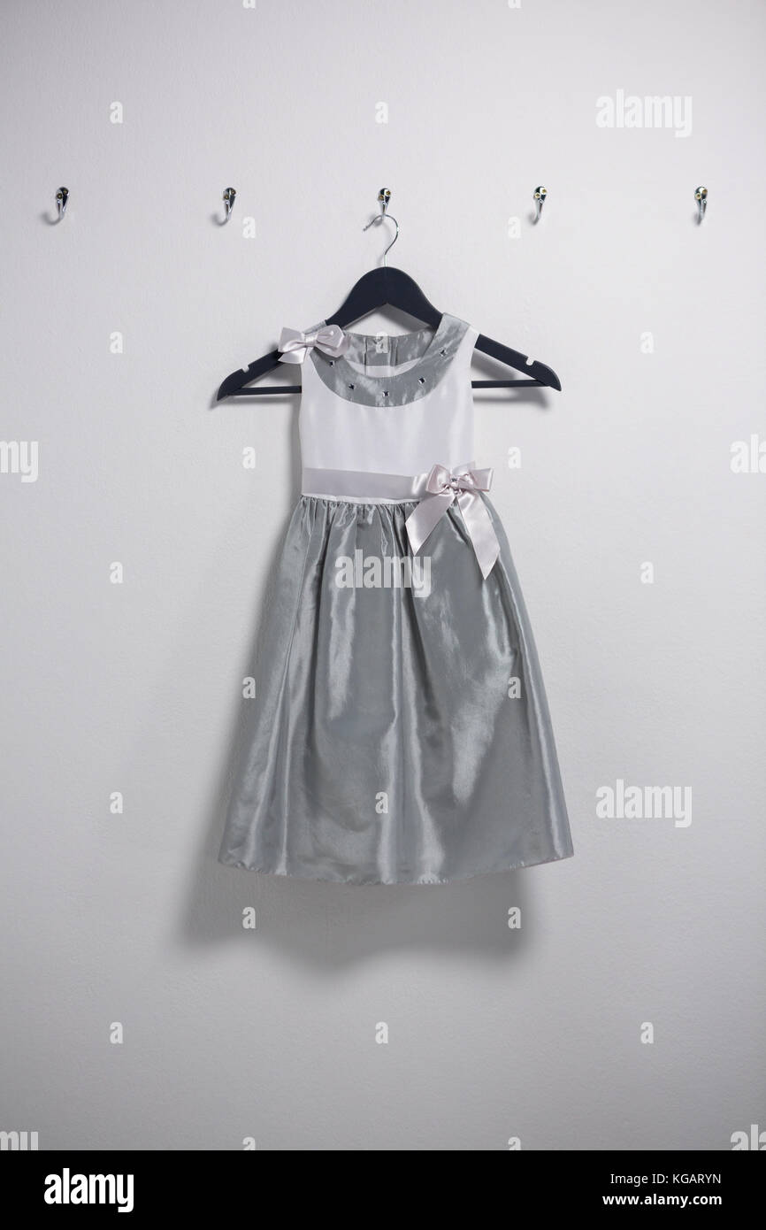 Dress hanging on hook against wall Stock Photo - Alamy