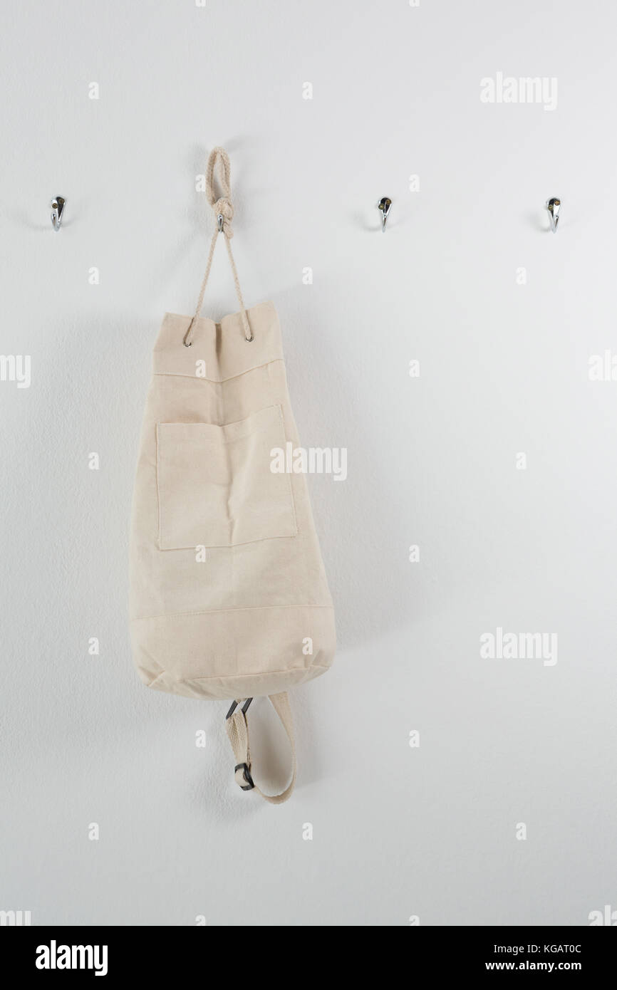 Bag hanging on hook against wall Stock Photo - Alamy
