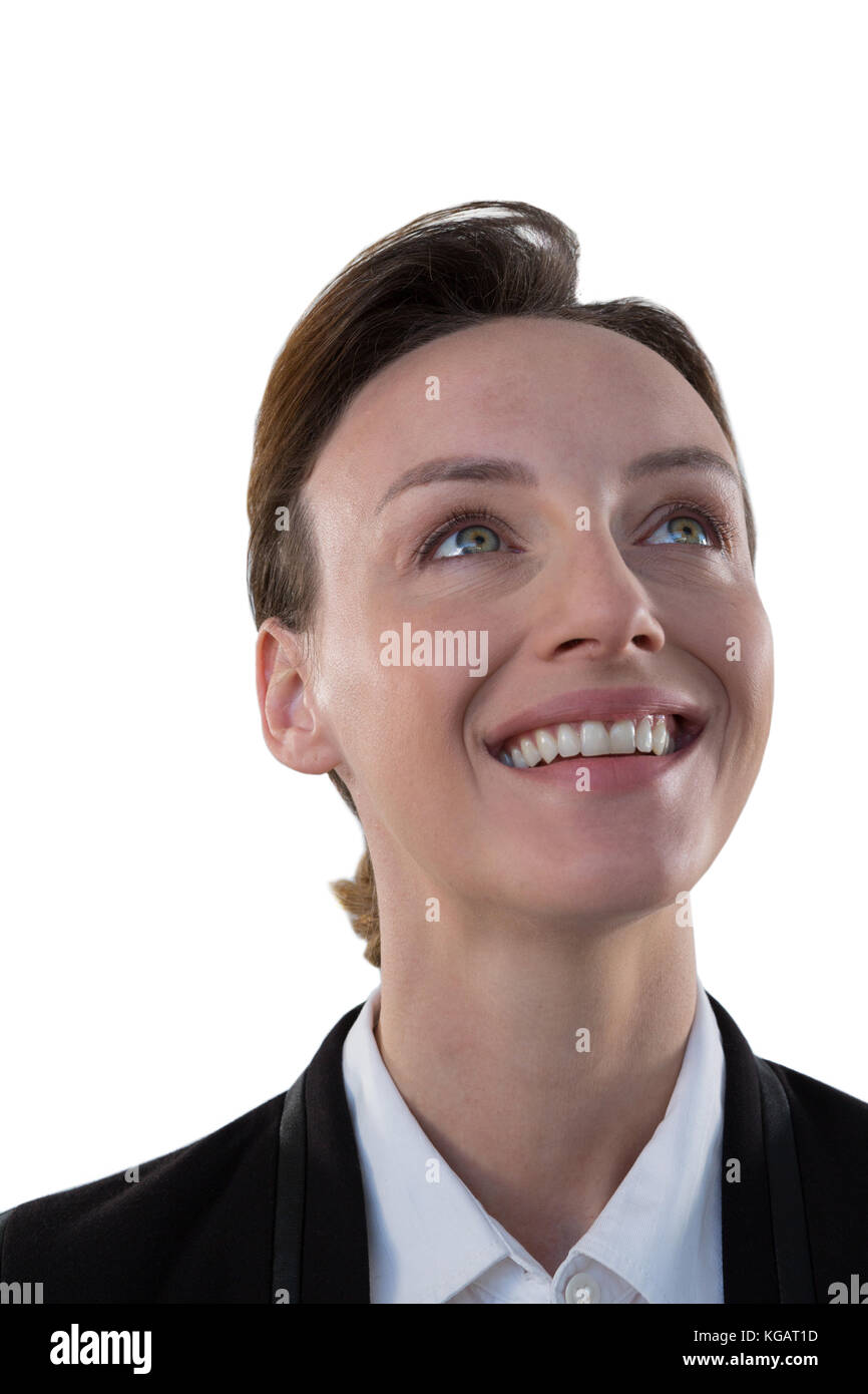 Thoughtful businesswoman smiling against white background Stock Photo ...
