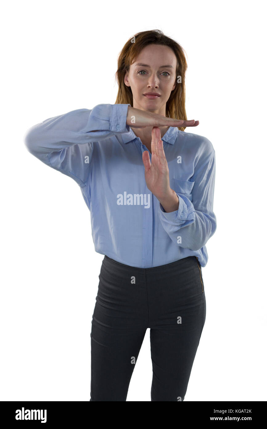 Female executive making time out sign against white background Stock ...