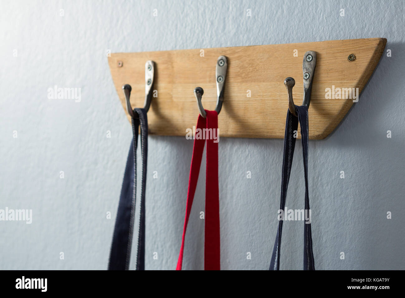 Close-up of various aprons hanging on hook Stock Photo - Alamy
