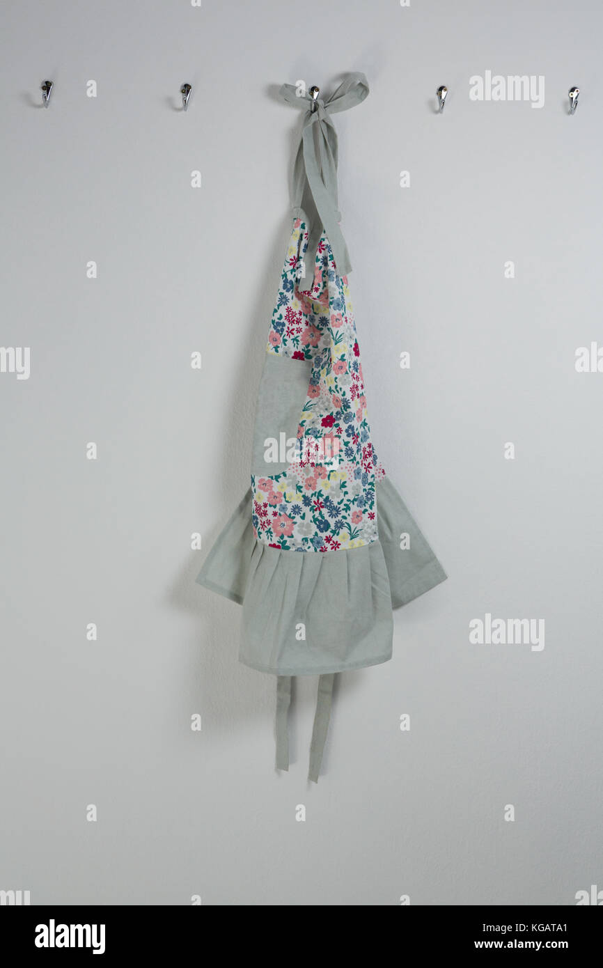 Apron hanging on hook against wall Stock Photo - Alamy
