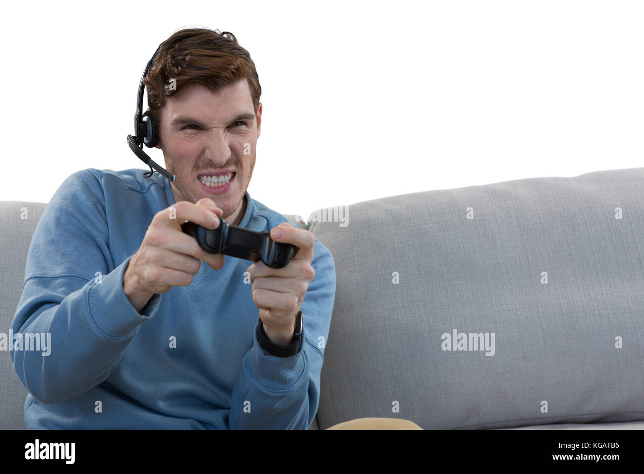 Young man playing video game against white background Stock Photo - Alamy