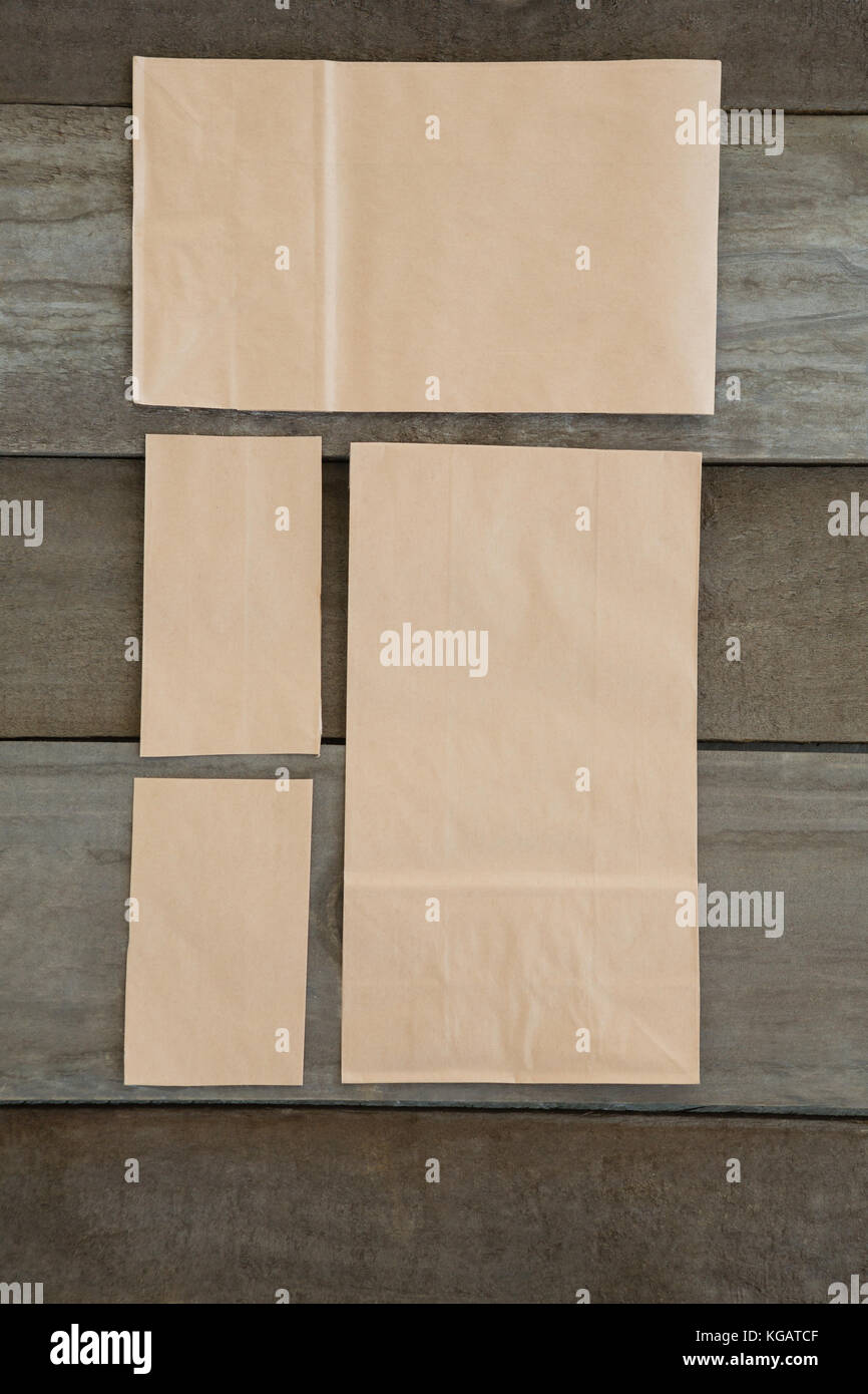 Brown color paper placed on wooden table Stock Photo - Alamy