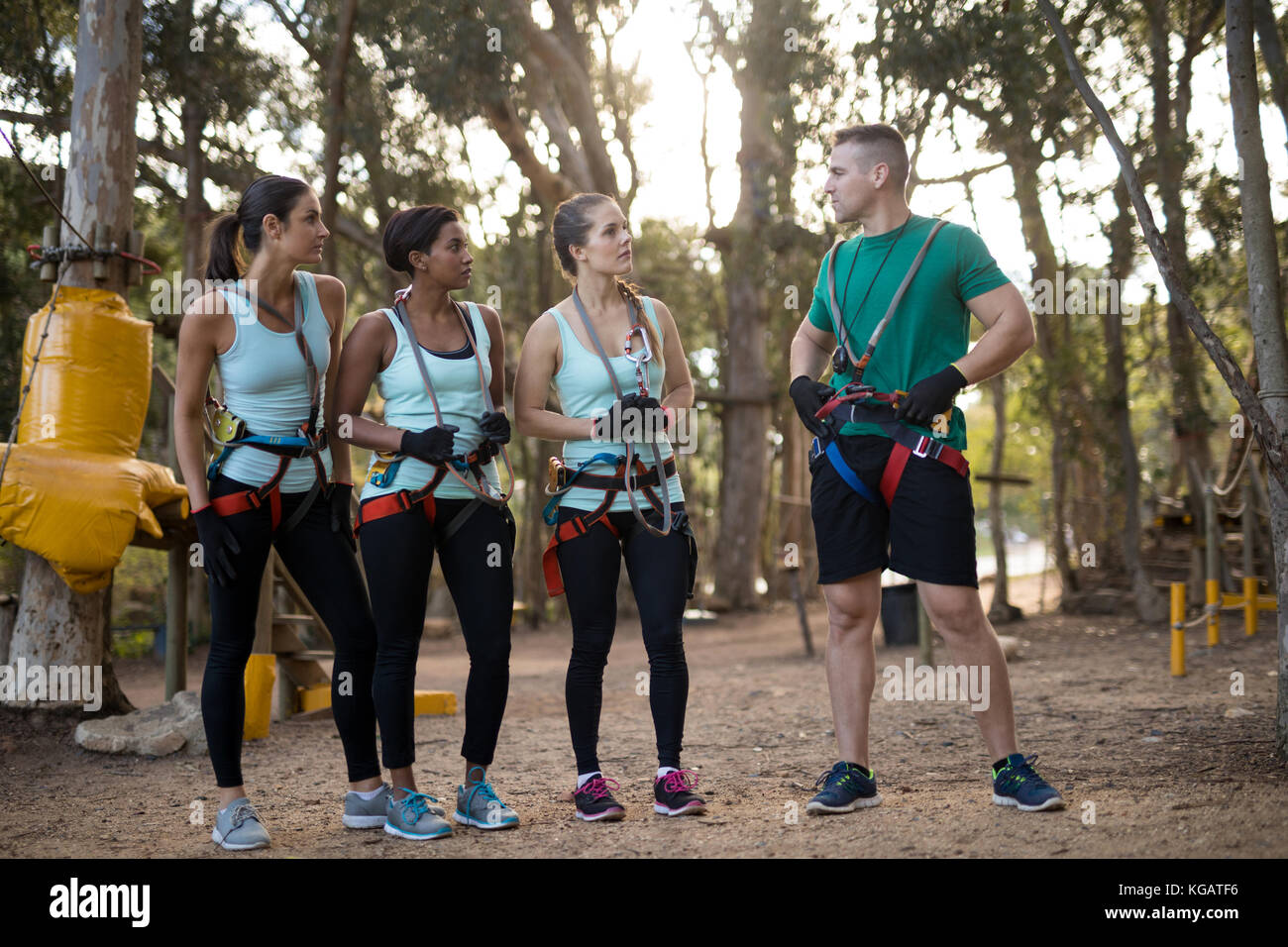 Happy coach and trainee interacting with each other in forest Stock ...