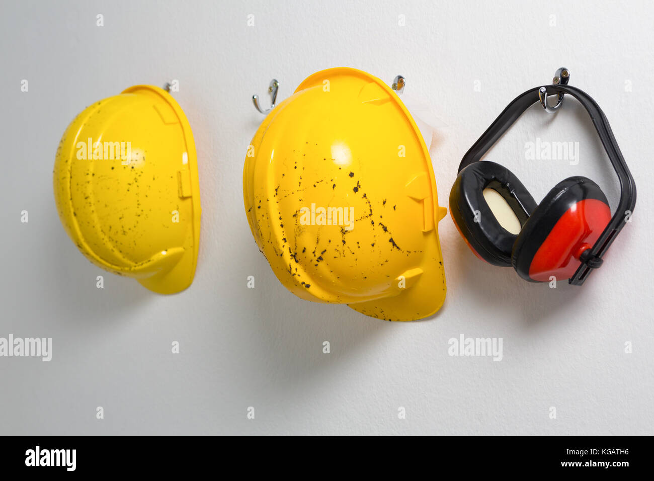 Hard hats hanging on wall hi-res stock photography and images - Alamy