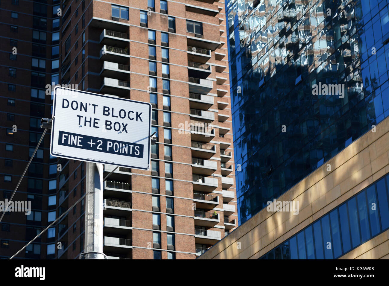 DON’T BLOCK THE BOX street sign in New York City, with diverse ...