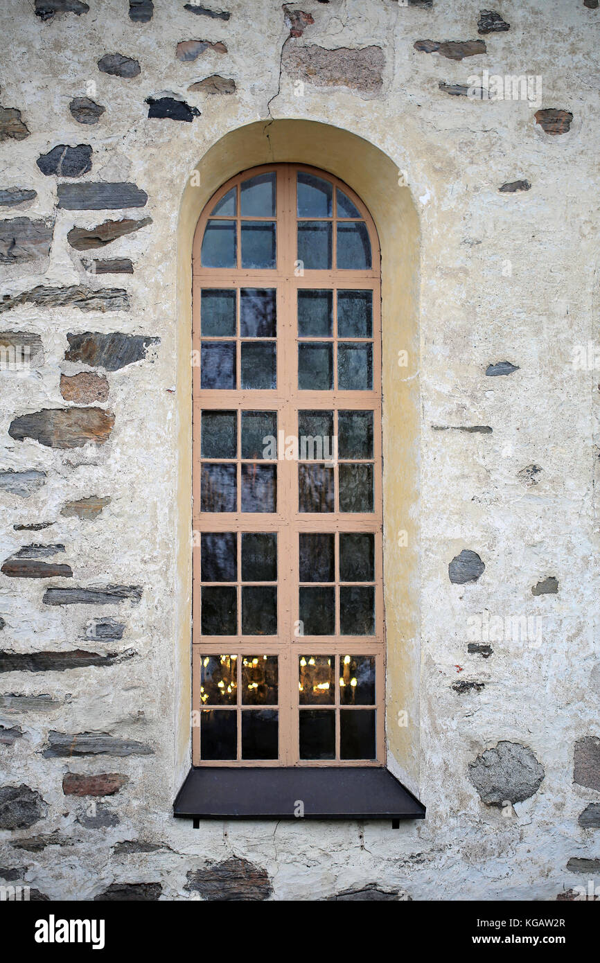 Arched window of a medieval stone church with candlelight Stock Photo ...