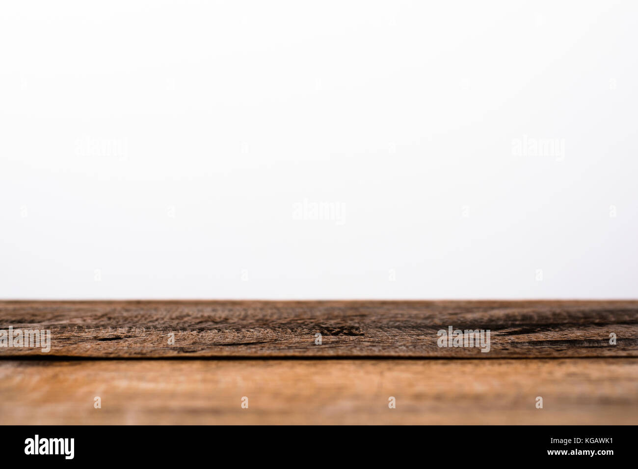 empty wooden table top isolated on white background, used for display ...