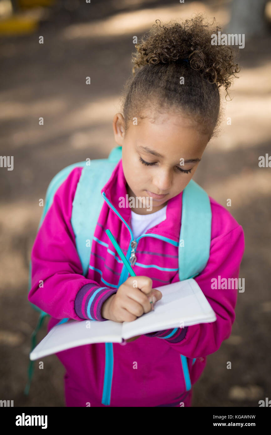 Girl writing in book hi-res stock photography and images - Alamy