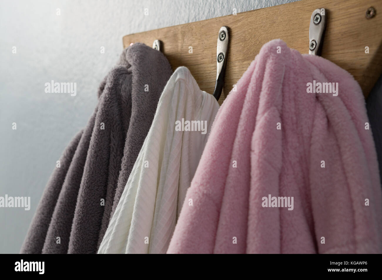 Close-up of bathrobes hanging on hook Stock Photo - Alamy