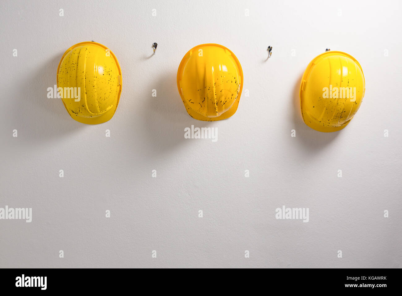 Hard hats hanging on wall hi-res stock photography and images - Alamy
