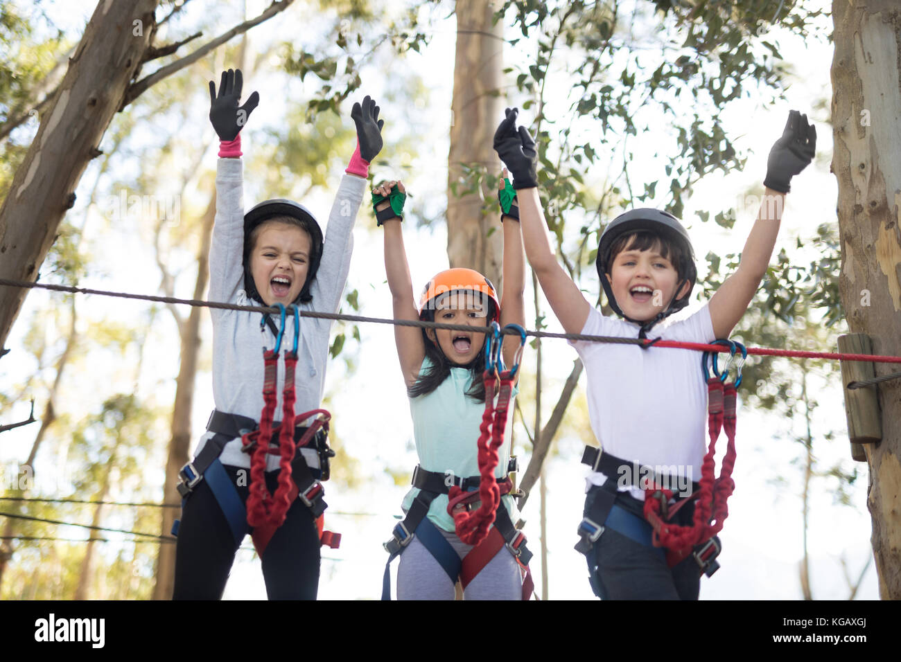 Portrait of happy kids cheering on bridge Stock Photo - Alamy