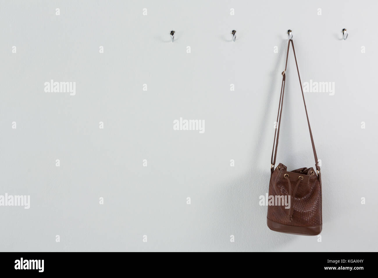 Bag hanging on hook against wall Stock Photo - Alamy