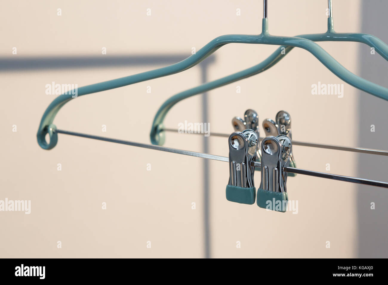 Close-up of empty cloth hanger with clothes peg Stock Photo - Alamy