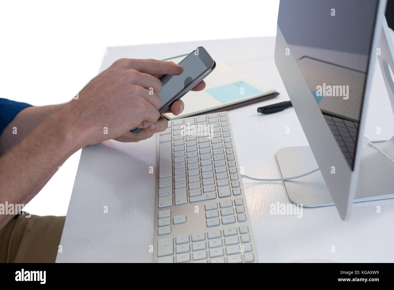 Close up of male executive using mobile phone at desk Stock Photo - Alamy