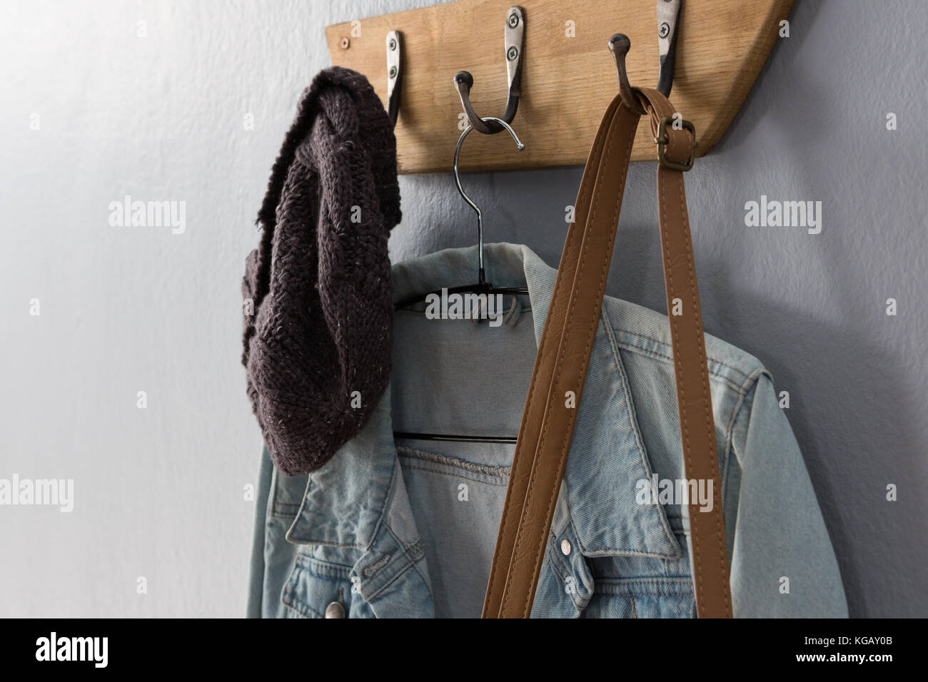 Close-up of denim jacket, hat and bag hanging on hook Stock Photo - Alamy