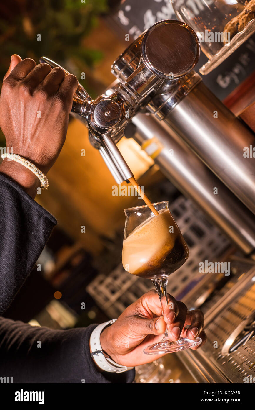 Waiter pours beer in a pub Stock Photo - Alamy