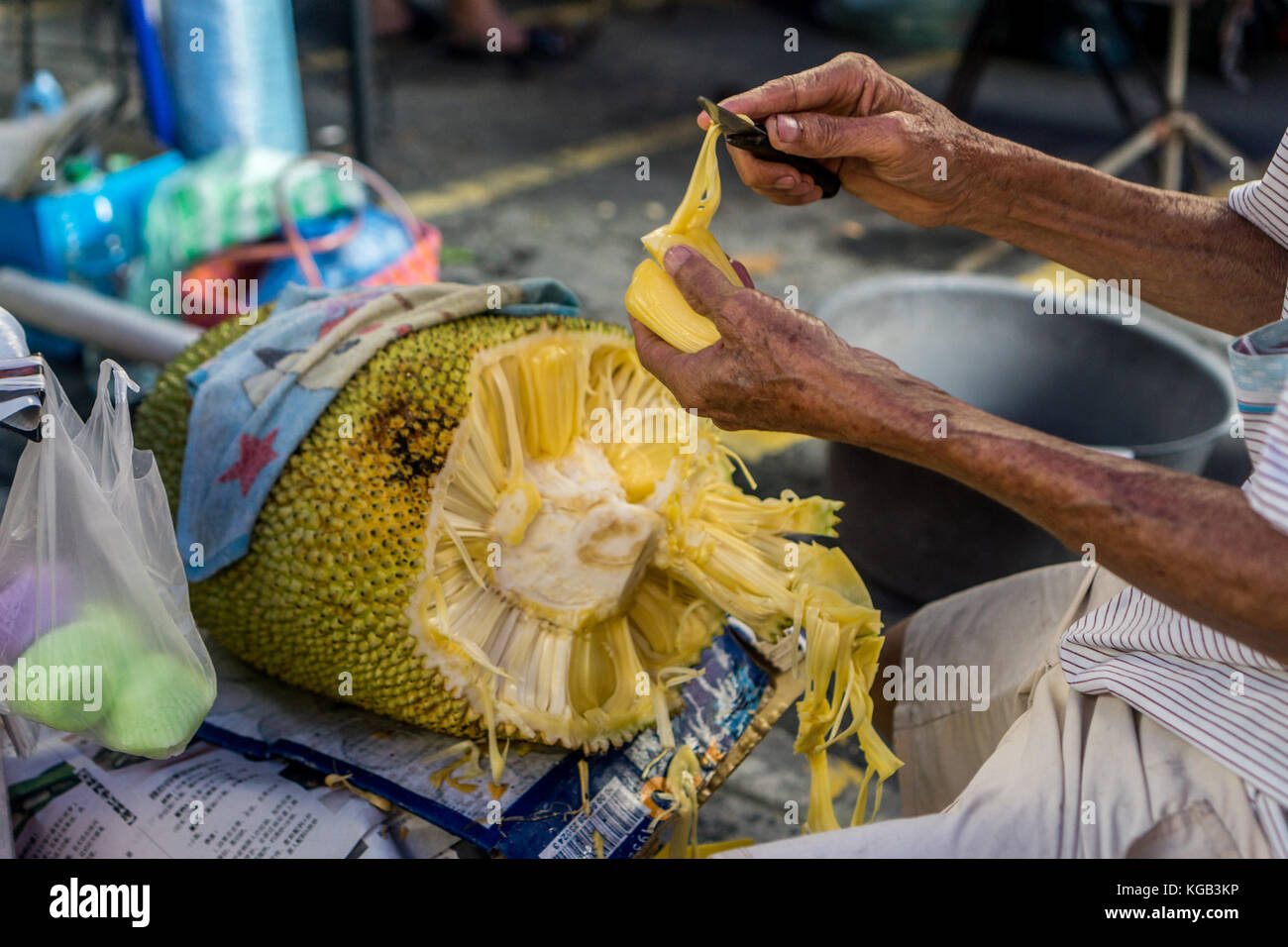 Cutting jackfruit in local market Stock Photo - Alamy