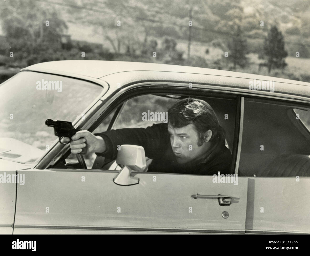 Man shooting from a car, unidentified movie Stock Photo - Alamy