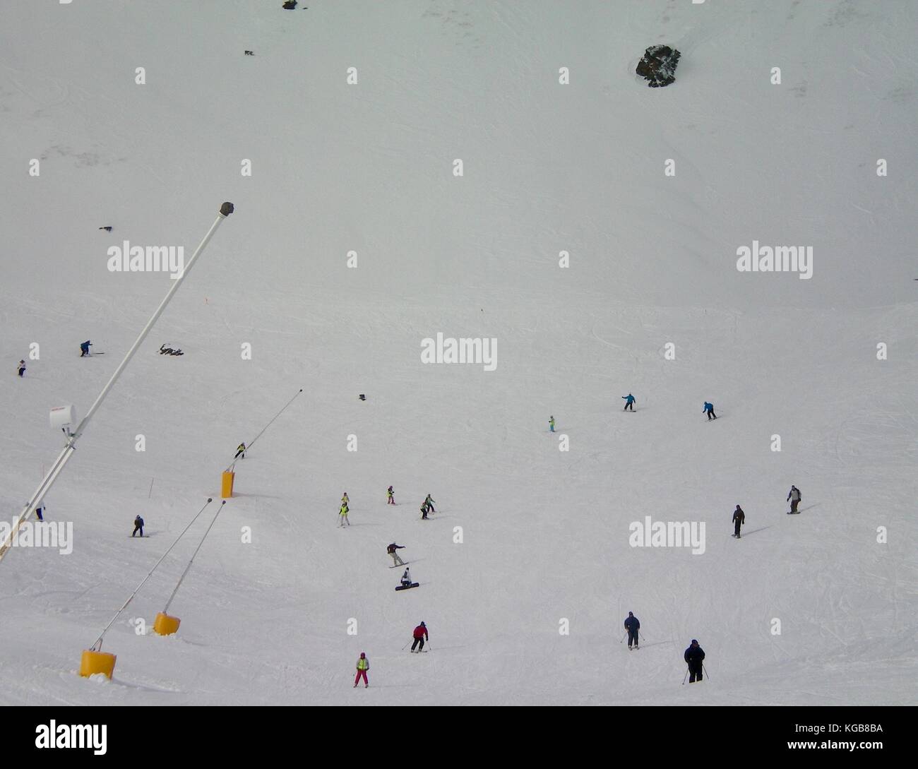 A groups of skiers on a snow-covered slope. The figures are very small ...